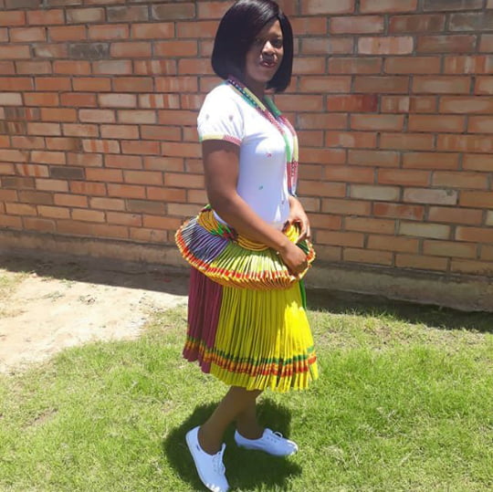 Clipkulture | Lady In Tsonga Xibelani Skirt With White Top and Sneakers