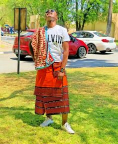 Man In Red Xhosa Traditional Umbhaco Skirt With White T-shirt and ...