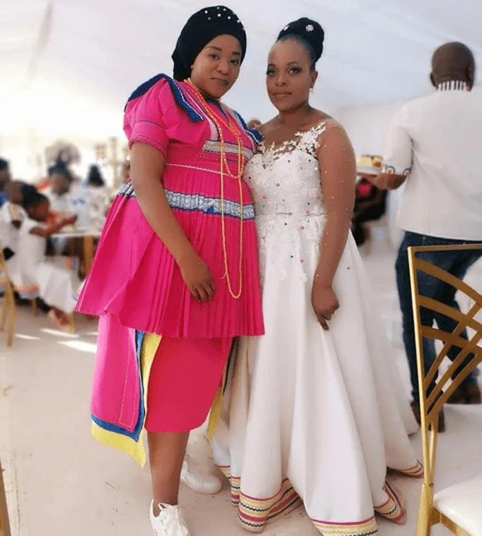Clipkulture | Bride In Beautiful White Beaded Sepedi Wedding Dress and Bridesmaid In Pink